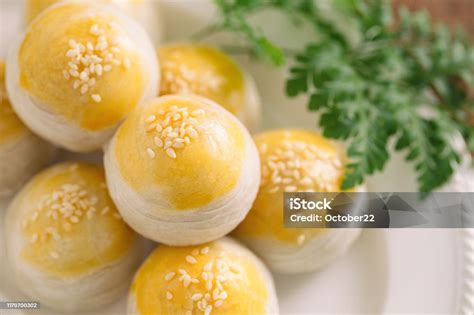 흰색 접시에 달콤한 녹두 페이스트와 소금에 절인 달걀 노른자를 가득 채운 중국 의 색박이나 달걀 케이크는 흰색 참깨로 장식 되어 있어 매크로 컨셉을 가까이서 볼 수 있습니다