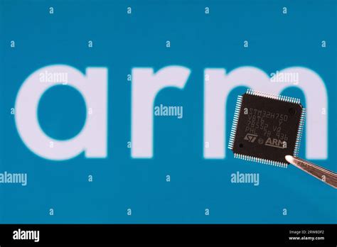 Arm Logo Seen On Stm32 Microchip Hold In Tweezers And Blurred Arm