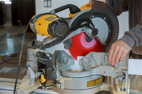 Premium Photo Handsome Young Man Carpenter Using A Circular Saw While
