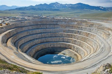 Vast Open Pit Mine Aerial View Of Concentric Rings And Central Pool