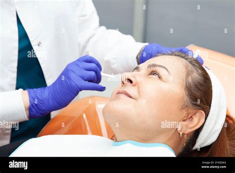 Dermatologist Marking Of Injection Points For Botulinum Toxin Application To A Middle Age Female