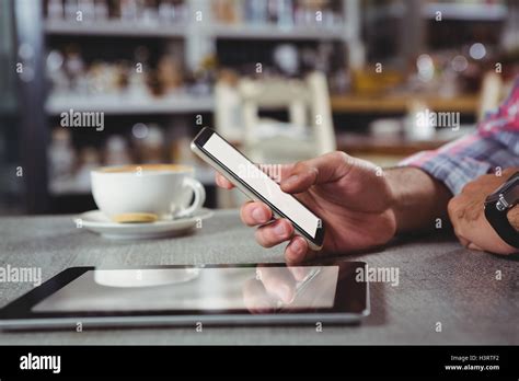 Hand Of Man Holding Mobile Phone Stock Photo Alamy
