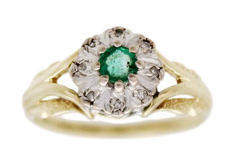Lot 178 An 18k Gold Emerald And Diamond Cluster Ring