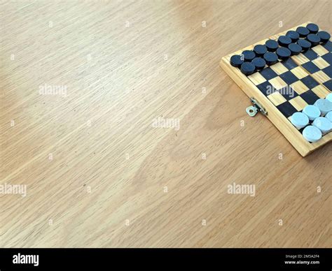 Checkerboard With Checkers Business Strategy Planning Plastic Checkerboard On Brown Wooden
