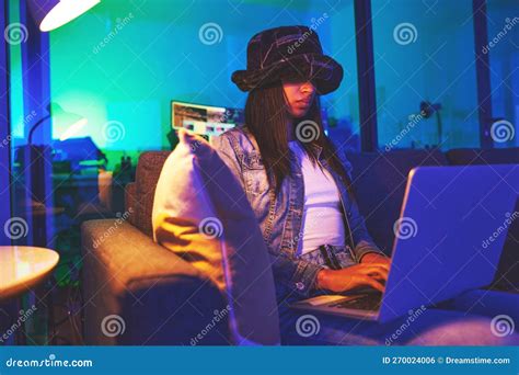 programmer hacker and woman typing on laptop in home at night in neon