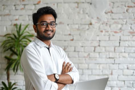 Premium Photo Portrait Of Cheerful Indian Programmer With Laptop