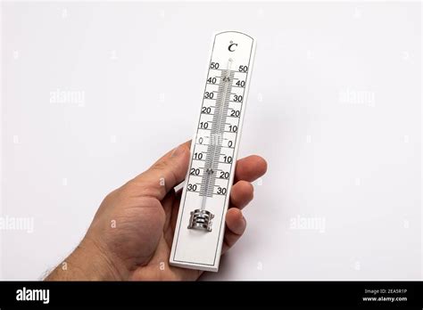 Wooden Thermometer With Celsius Scale In A Man S Hand On A White Background Stock Photo Alamy