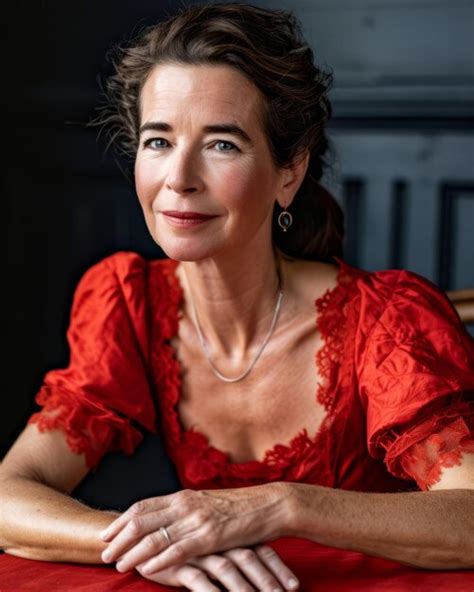 Premium Photo A Woman In A Red Dress Sitting At A Table
