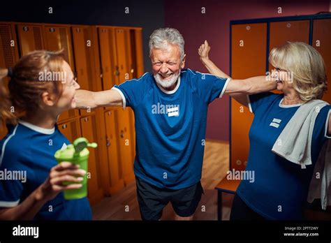 Sports Team Of Seniors And Young Woman Feeling Joyful In Locker Room Sharing Joy Together Man