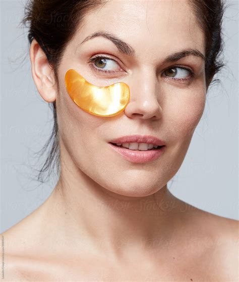 Woman Using Gel Eye Patch Mask By Stocksy Contributor Leandro Crespi Stocksy