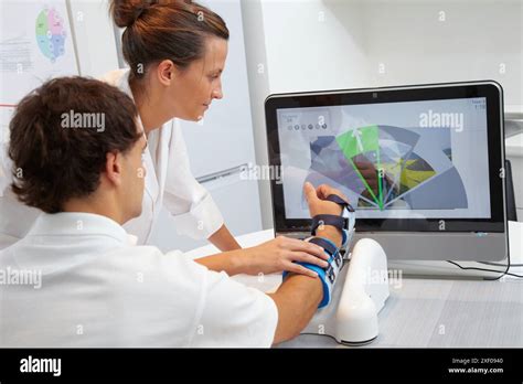Investigator And Patient With Assistive Robot For Upper Limb