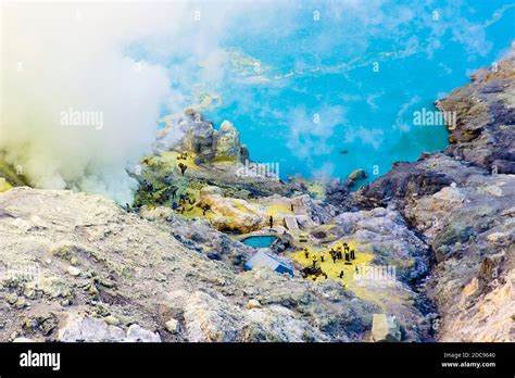 Birds Eye View Of Sulphur Miners Working By The Turquoise Acid Crater