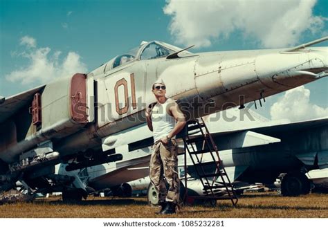 Fighter Pilot With Sunglasses In Full Flight Gear Standing At The Front