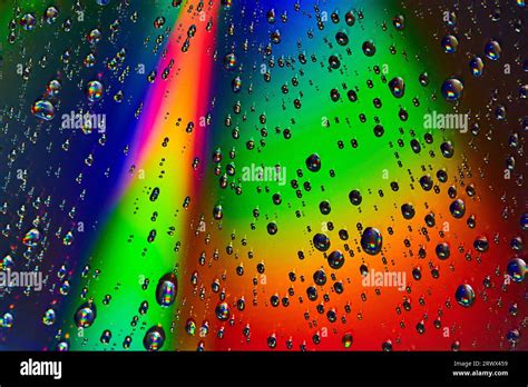 Beam Of Light Across Abstract Rainbow Colored Background With Rain
