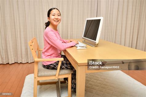 Japanese Girl Operating Personal Computer In The Living Room Stock