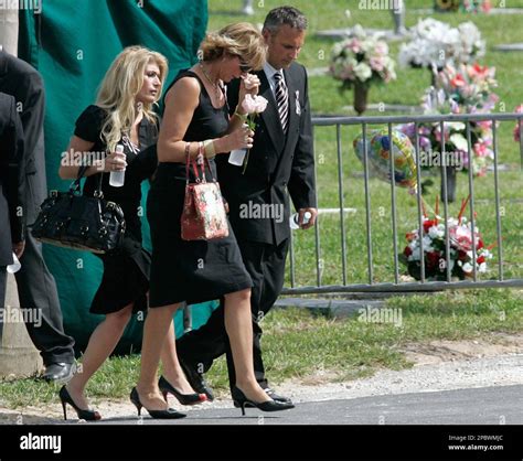 An Unidentified Guest Weeps While Leaving The Cemetery After The Burial