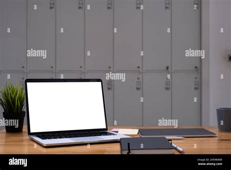 Image Of Mock Up Laptop Computer On Wooden Desk In Office Blank Screen For Your Advertising