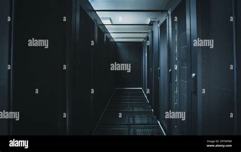 It Engineer Standing Before Working Server Rack Doing Routine