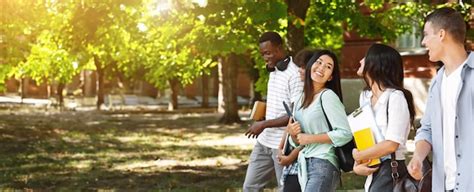 Premium Photo Joyful College Friends Walking Outdoors After Classes