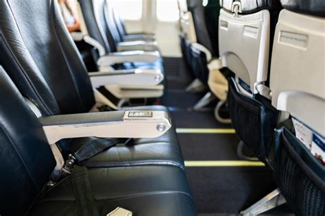 Premium Photo Seats Inside A Plane With Seatbealts And Chairs In