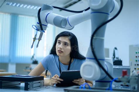 Female Robotics Engineer Working With Programming And Manipulating