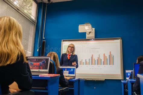Adult Female Teacher Lecturing The Students In The Classroom Stock