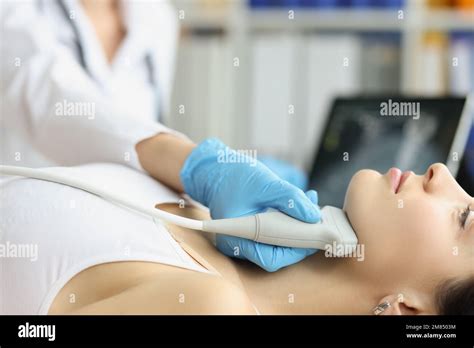 Doctor Diagnoses Thyroid Gland On Ultrasound Machine Closeup Stock