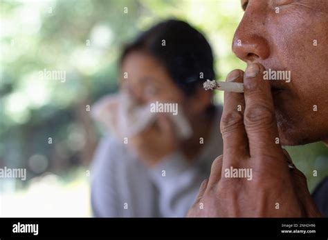Passive Smoking Concept Man Is Smoking Cigarette And Woman Is Covering