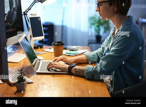 Female Programmer Working In Office At Night Stock Photo Alamy
