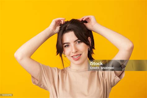 Studio Portrait Of A Cheerful 20 Year Old White Woman With Black Hair