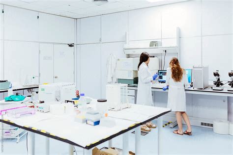 Two Young Biologists In Laboratory By Stocksy Contributor Victor Torres Stocksy