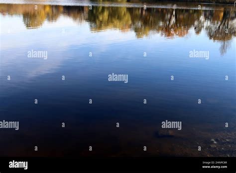 Detailed Close Up View On Water Surfaces With Waves And Ripples And The Sunlight Reflecting At