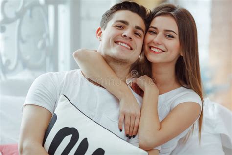 Cute Couple In Love Spending Time Together Woman Embracing Her Partner In Bed Stock Photo
