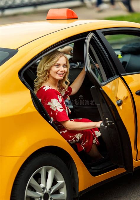 Photo Of Blonde In Red Dress Sitting In Taxi On Summer Stock Image