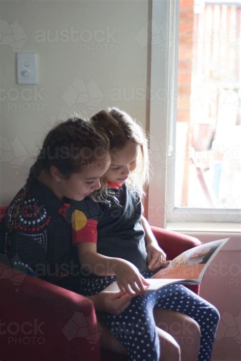 Image Of Sisters Reading Together Austockphoto