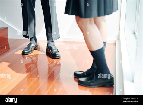 The Feet Of Male And Female High School Students Talking On The Dance