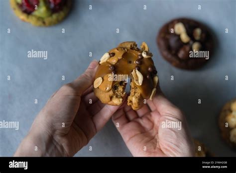 Woman Breaks Homemade American Traditional Chocolate Chip Cookie With Peanut Butter Sticky