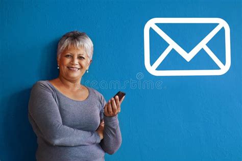 Make Someones Day Send Them A Message A Mature Woman Holding A Mobile