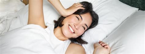 Free Photo Close Up Of Happy Asian Girl Lying In Bed On Her Pillow