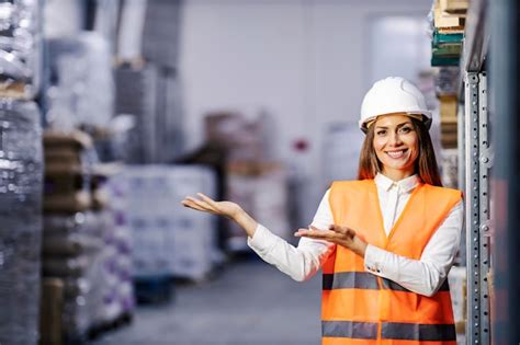 Premium Photo A Happy Inspector Showing At Empty Space At Warehouse