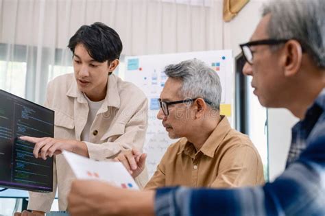 group of asian senior in a collaborative software development analyzing