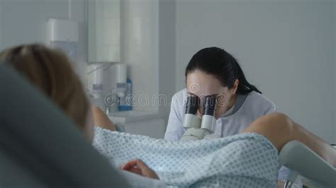 Female Gynecologist Uses Colposcope Takes Tests From Patient Stock