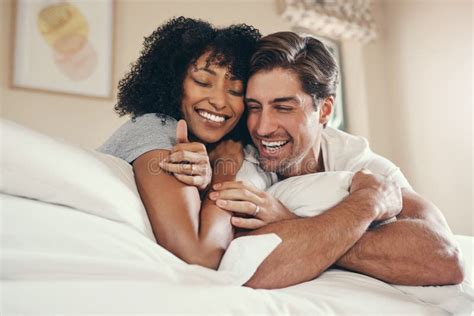 Interracial Couple Relax And Hug On Bed In Morning For Love Support And Partner In Apartment