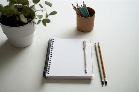 Premium Ai Image A Planning Notebook And Pencil Are Displayed Against A Background Of A White Wall