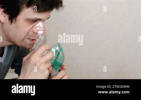 Use Nebulizer And Inhaler For The Treatment Young Man Inhaling Through