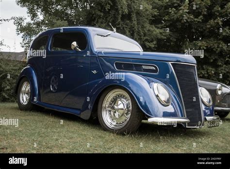 Side View Of A Blue Restored 1955 Ford Popular Hot Rod On Display At