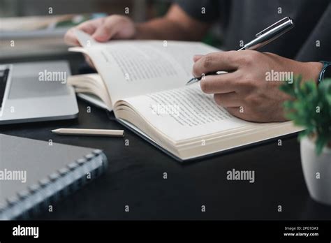 Learning Online Class By Using Laptop Computer And Writing Notebook At