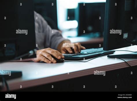 Hands Typing On A Keyboard And Using A Mouse At A Busy Training Center