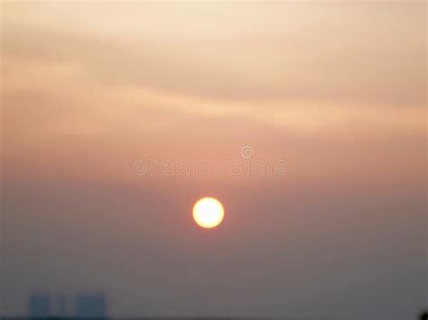 A Tranquil Sunset Scene With The Bright Orb Of The Sun Melting Into A