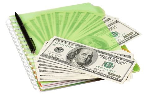 Premium Photo Heap Of Dollars And Exercise Book Isolated On A White